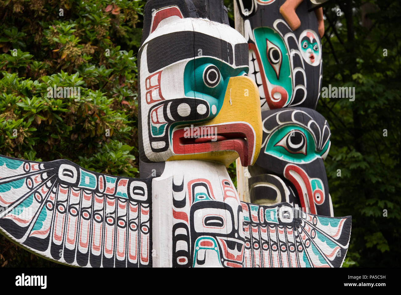 Colorful totem poles depicting stories through carvings of mystical ...