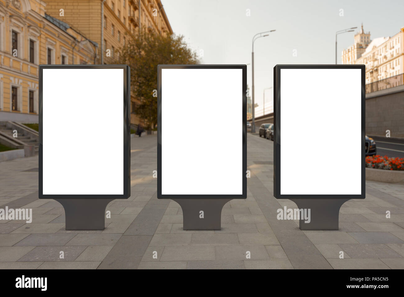 Three blank vertical street billboard posters on city background. 3d ...