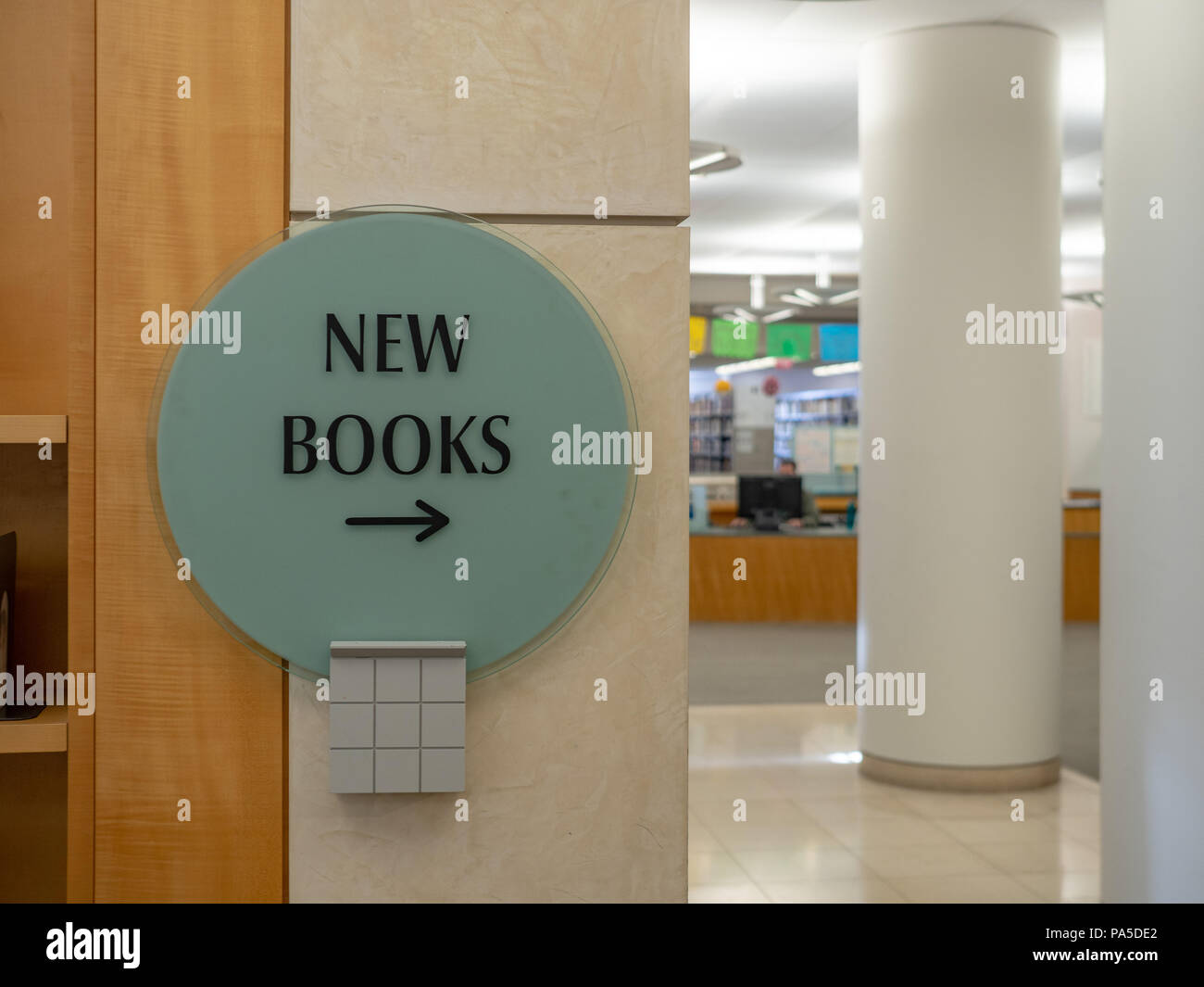 New books sign pointing to the right with library in background Stock ...