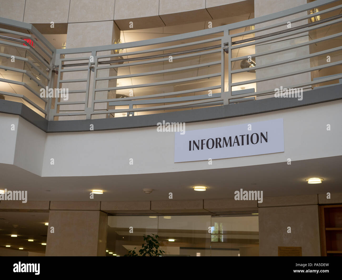 Plain information sign hanging in a large, modern room Stock Photo - Alamy