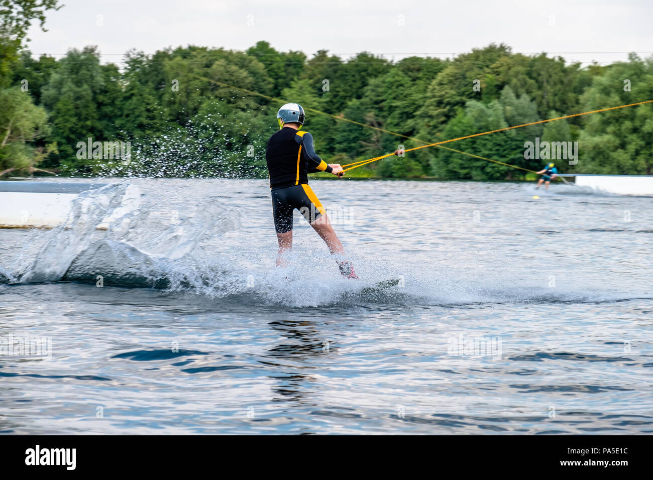 Boy having fun with waterski on the lake Stock Photo - Alamy