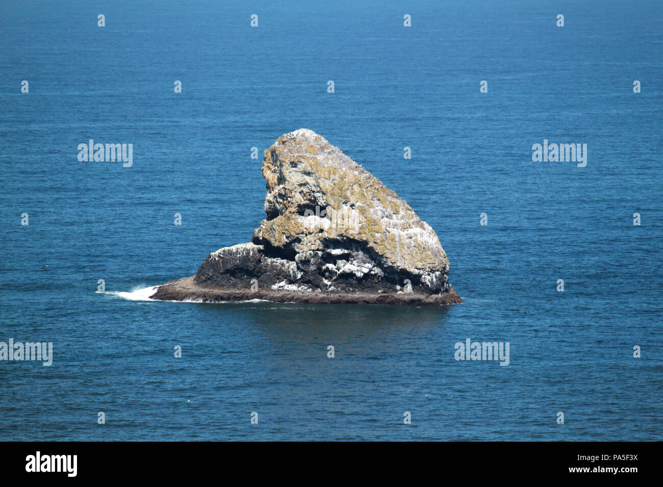 A triangular shaped island in the middle of a blue water Stock Photo ...