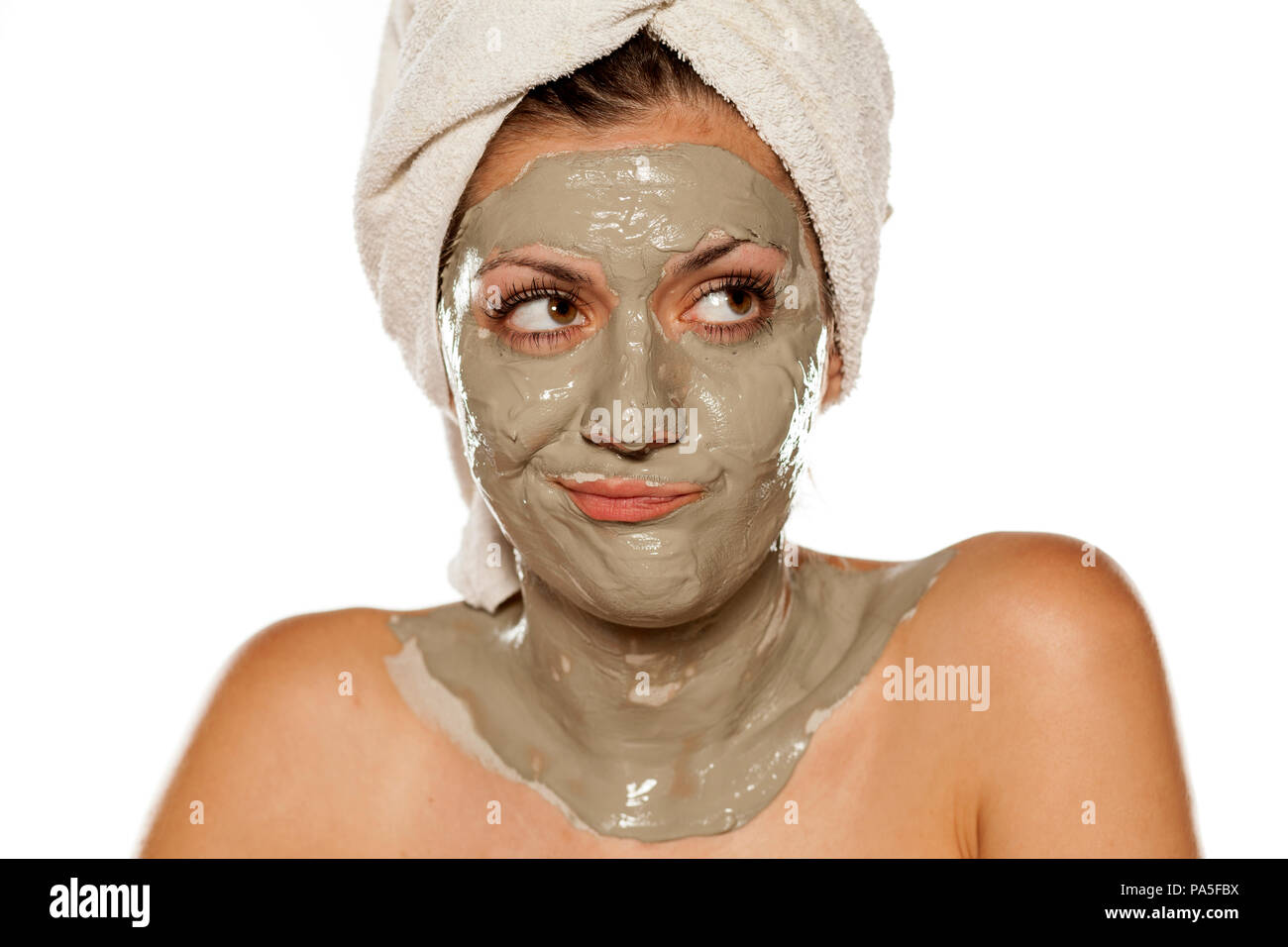 young woman feels bored with the green clay mask on her face Stock ...