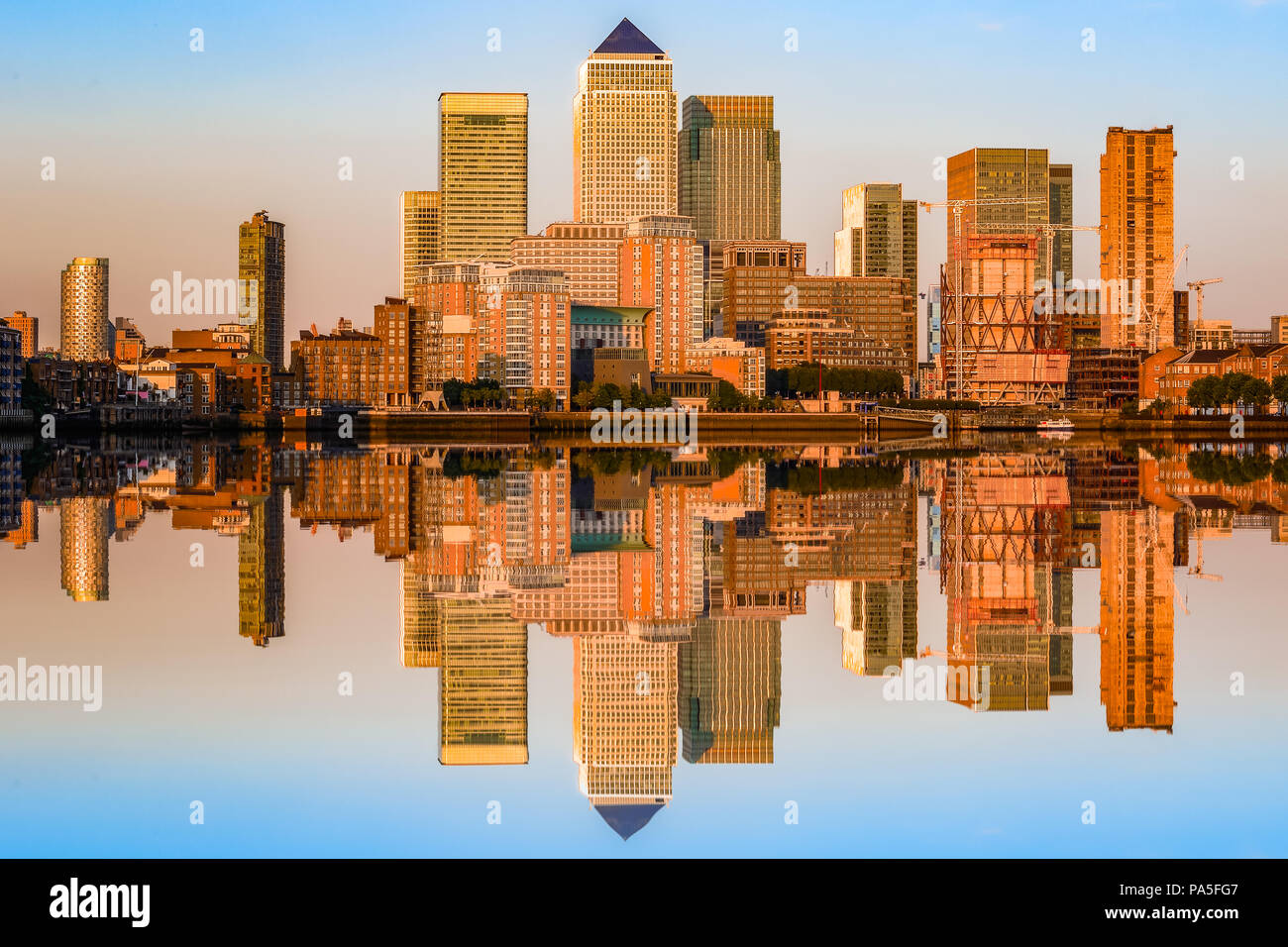 Golden sunset at Canary Wharf and its reflection from river Thames ...