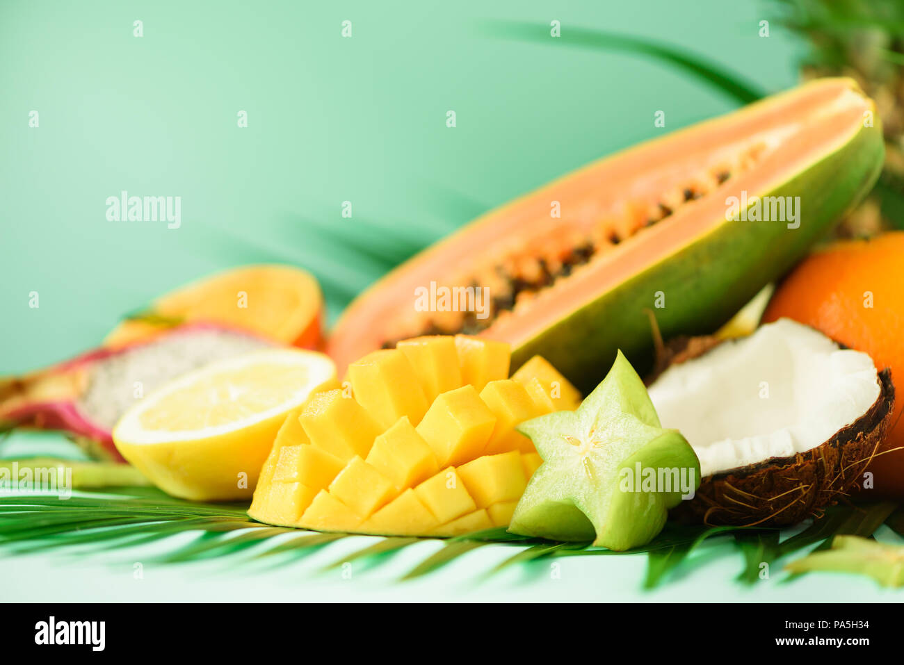 Assortment of exotic fruits on turquoise background. Detox, vegan food ...