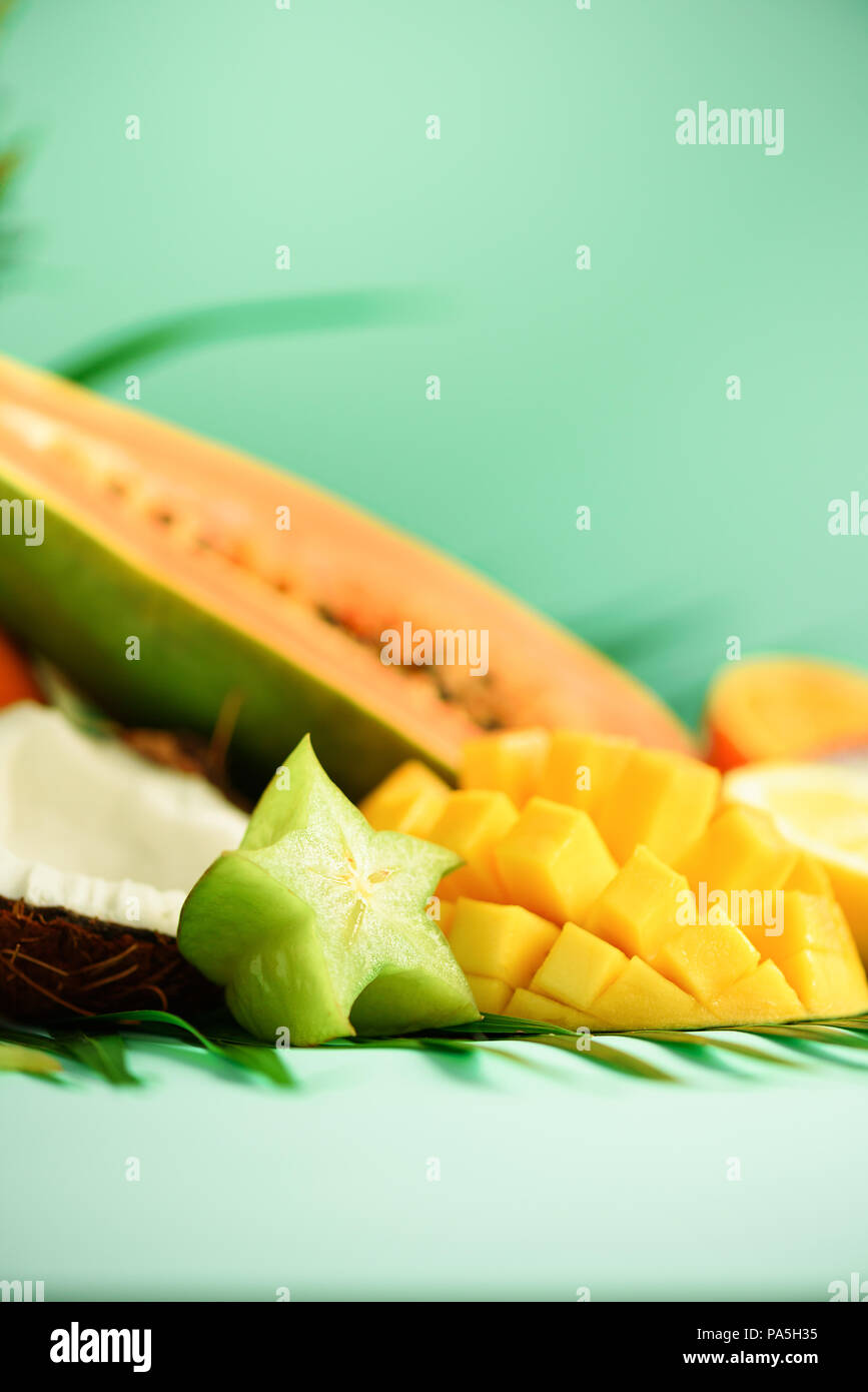 Assortment of exotic fruits on turquoise background. Detox, vegan food ...