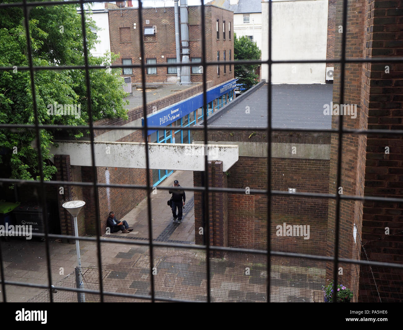 Person ignoring homeless person sitting in walkway begging Stock Photo ...