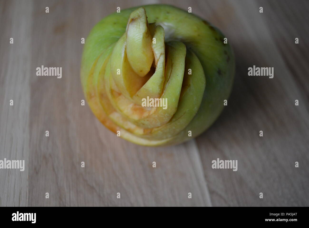 Fresh green apple with slices of apple and apple slide on a light ...