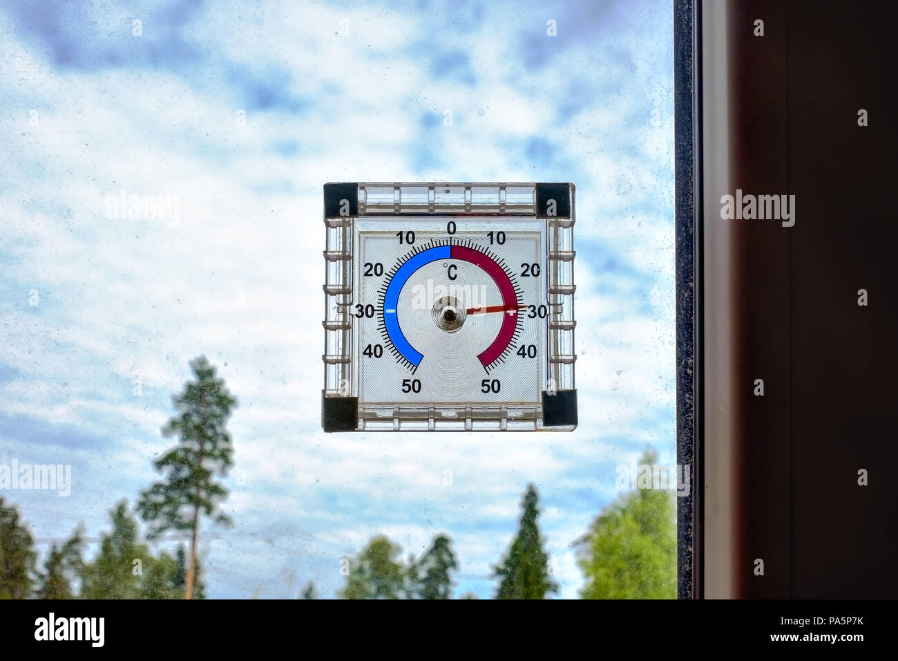 A thermometer on glass of window showing hot temperature outdoor Stock ...