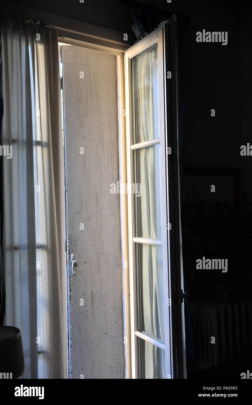 Early morning looking out of an open window and shutters leading to the ...