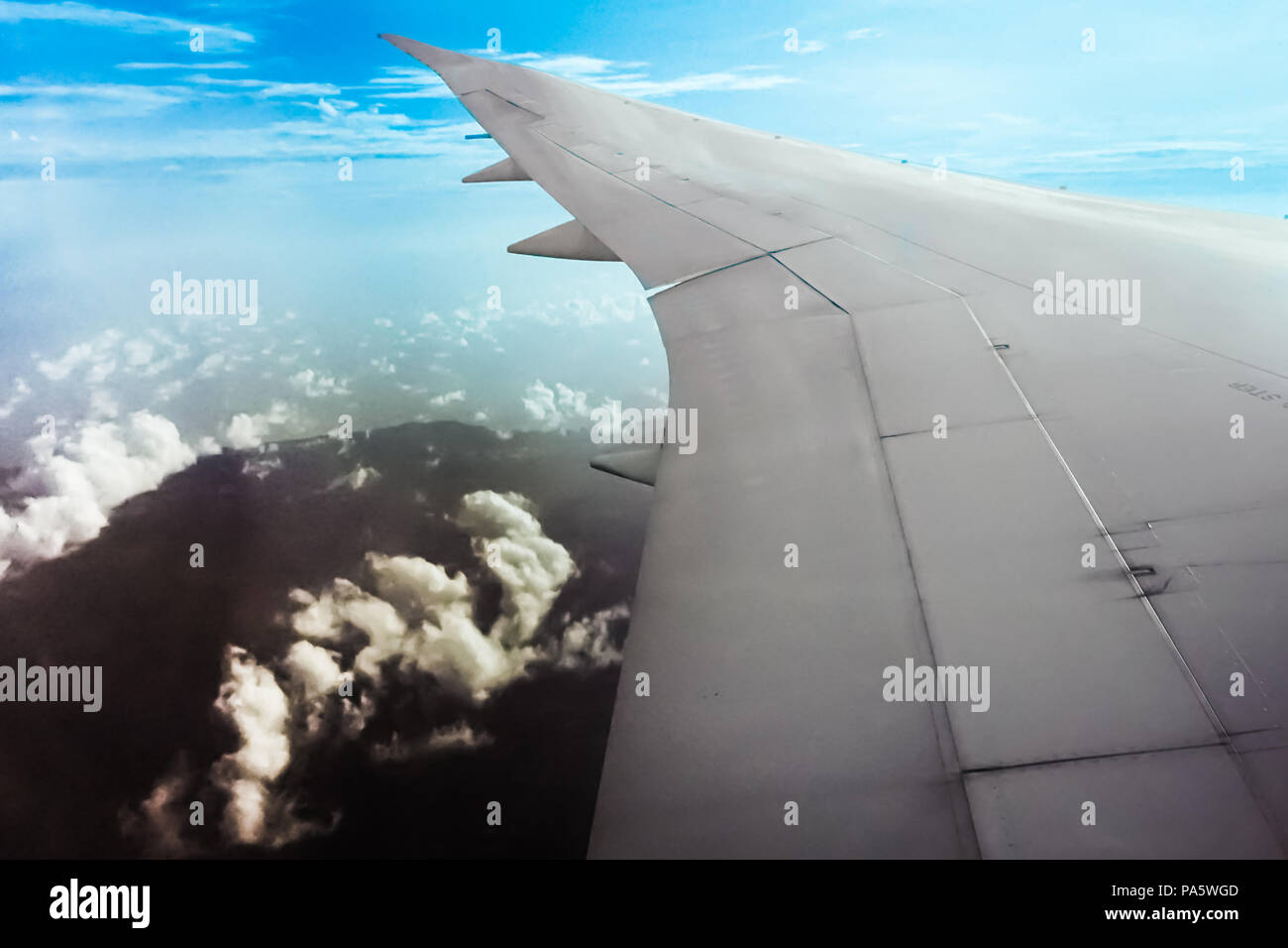 Commercial aircraft wing pointing in the blue sky evoke a wonderful ...