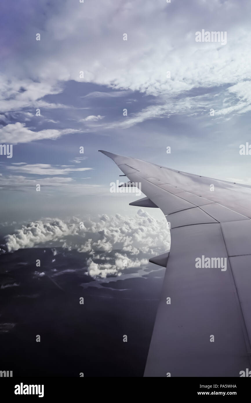 Commercial aircraft wing pointing in the blue sky evoke a wonderful ...