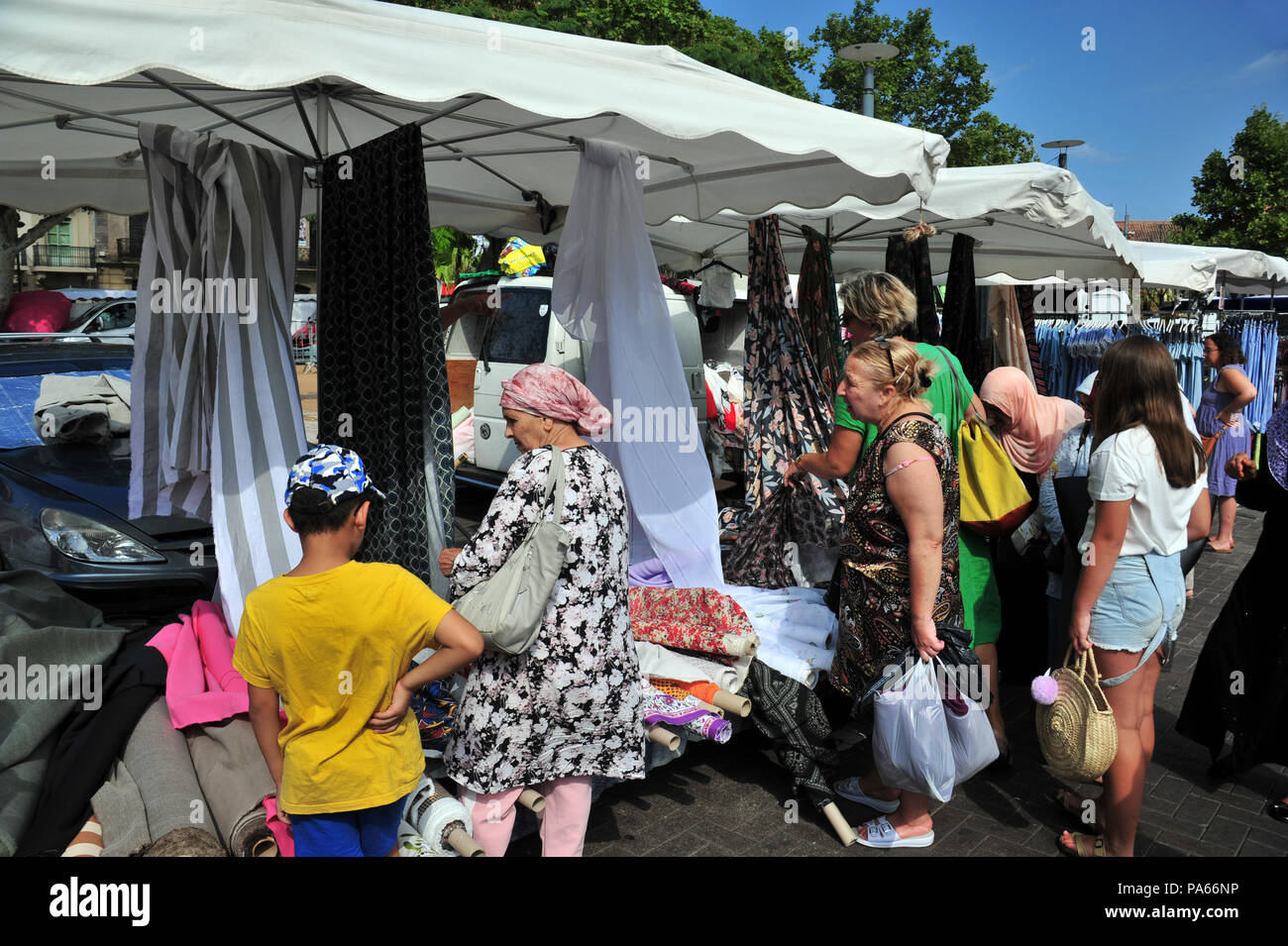Crowded alleyways at the busy friday clothes market held each week in Beziers, France Stock ...