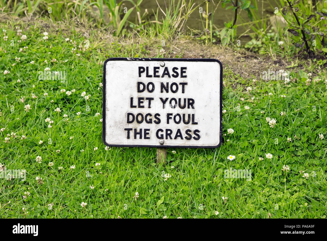 A photography of a sign in the grass Stock Photo - Alamy