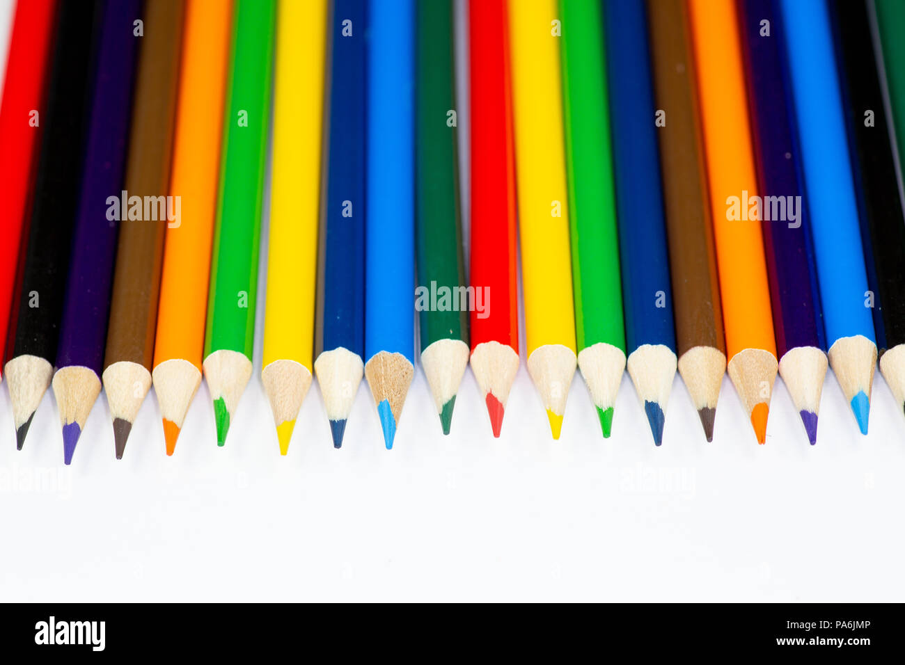 Color pencils lined up in a row against a white background Stock Photo ...