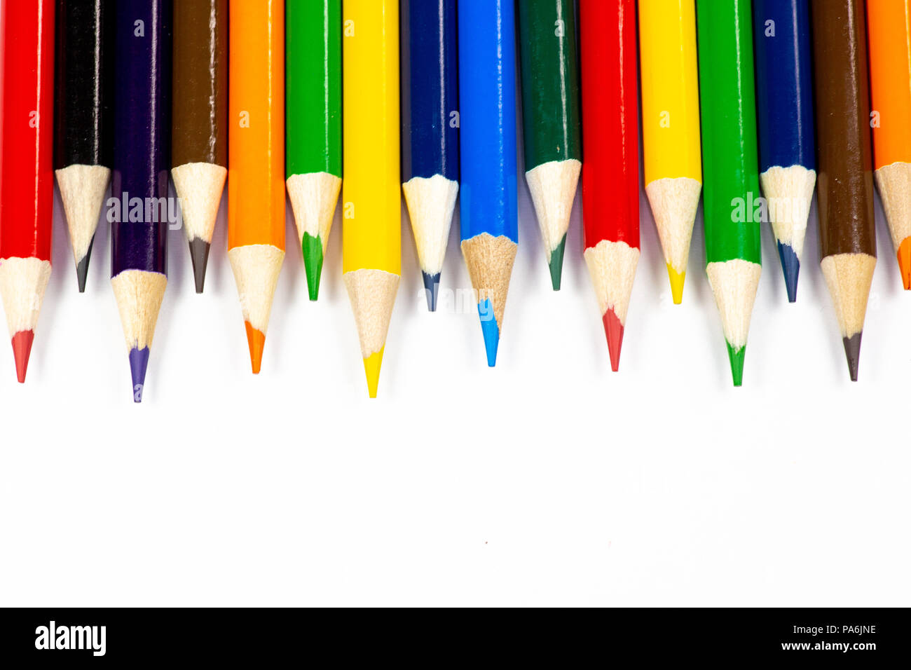 Color pencils lined up in a row against a white background Stock Photo - Alamy