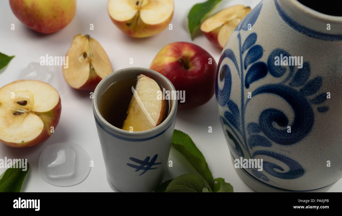 Traditional Frankfurt apple wine in a jug bembel with beaker and apples ...