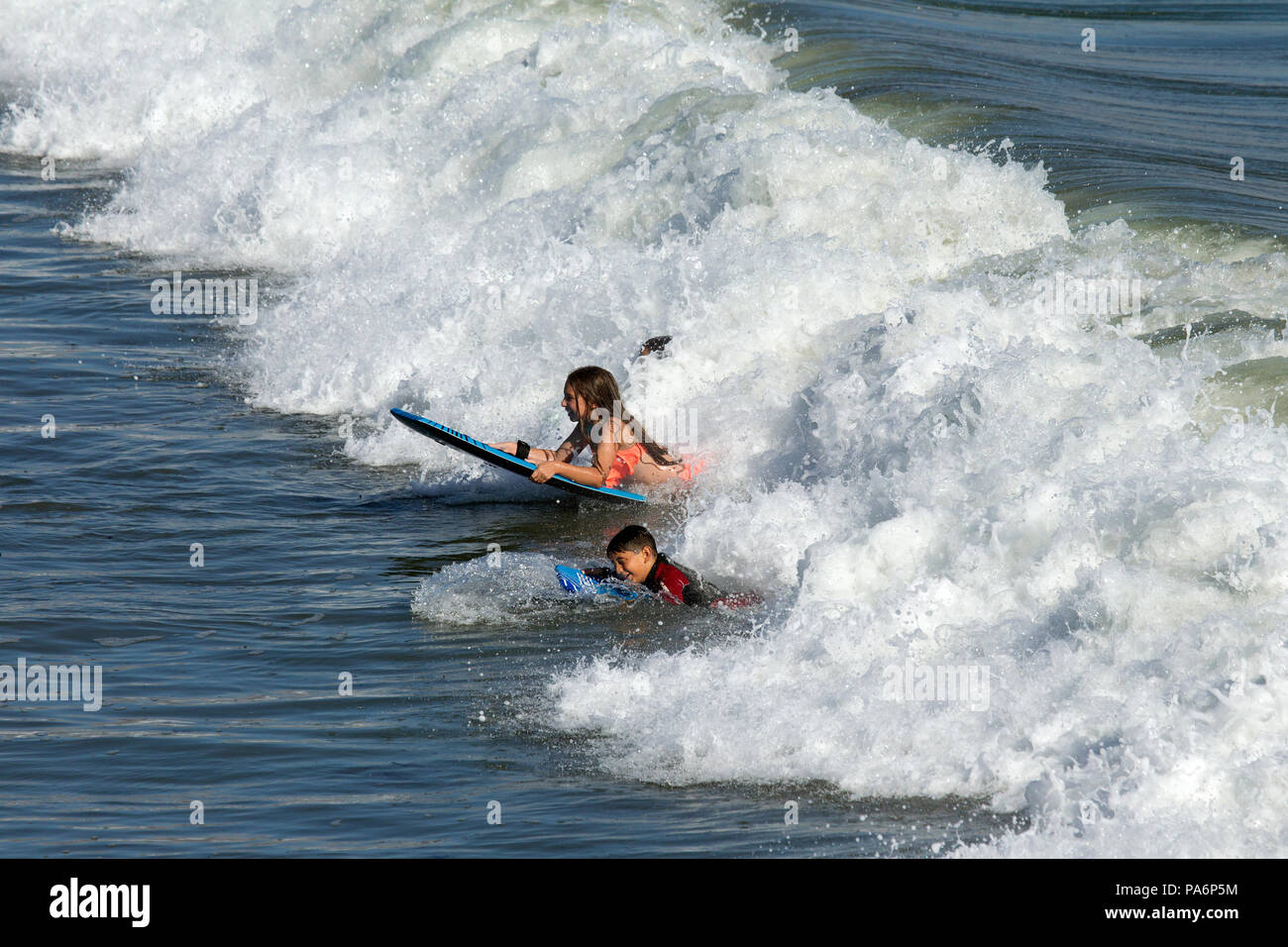 Young Boy and Young Girl on Boogie Boards in a Breaking Wave Stock ...