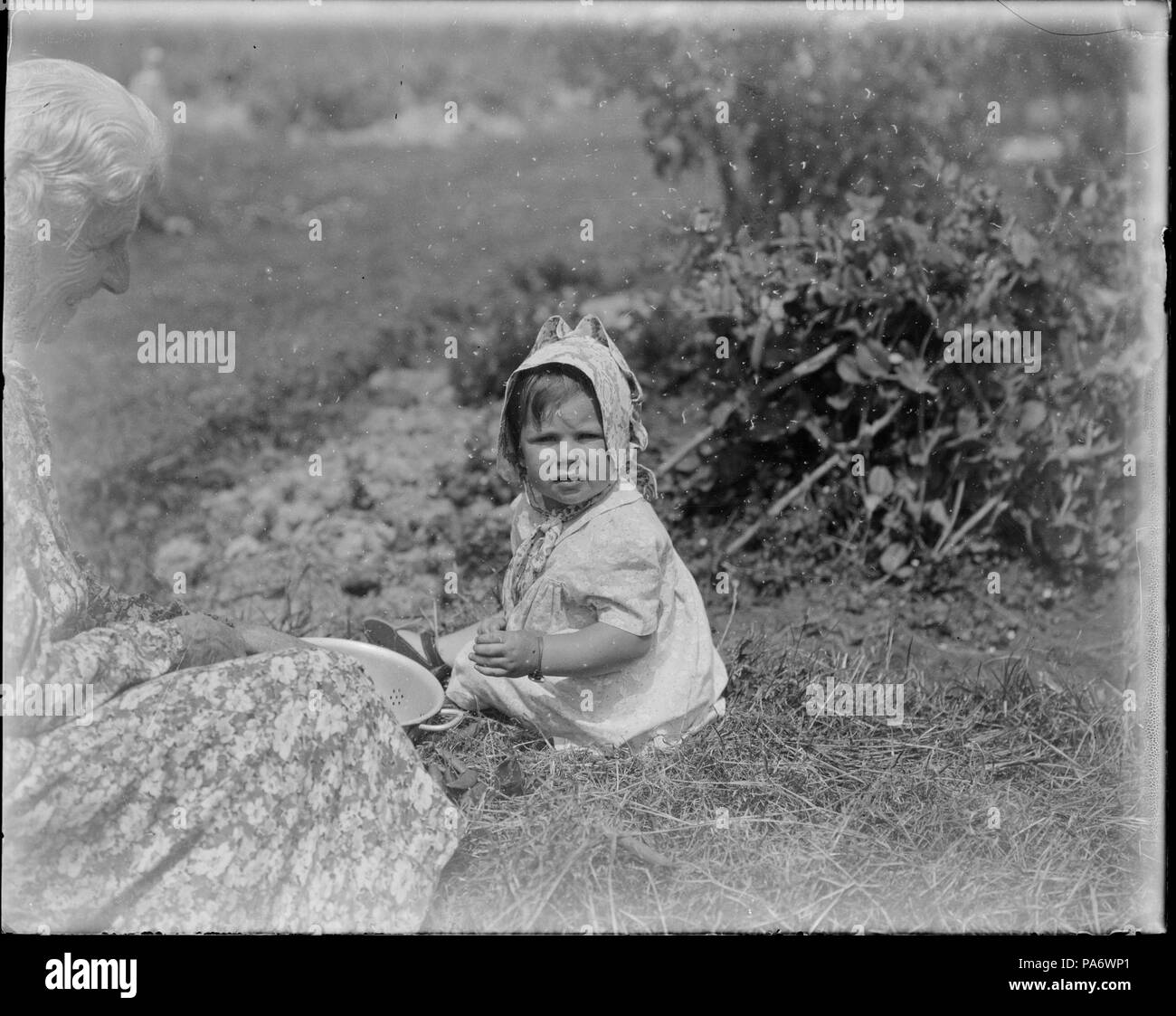 18 An unidentified child and older woman (possibly Laura Godber) seated ...