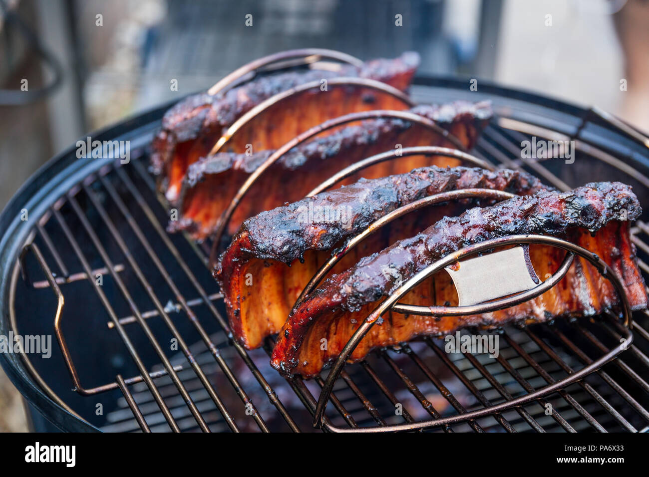 Cooking marinated baby back ribs on an outdoor barbecue Stock Photo - Alamy