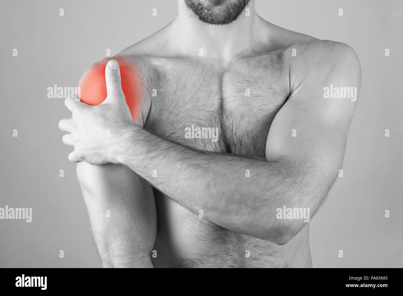 Man with shoulder pain over grey background Stock Photo - Alamy
