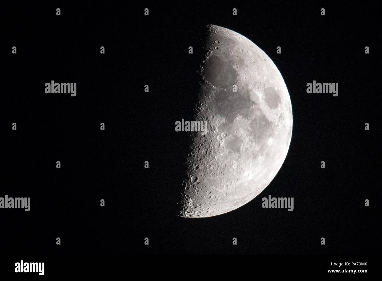 19 July 2018, Germany, Cologne: A perfect half moon appears in the ...