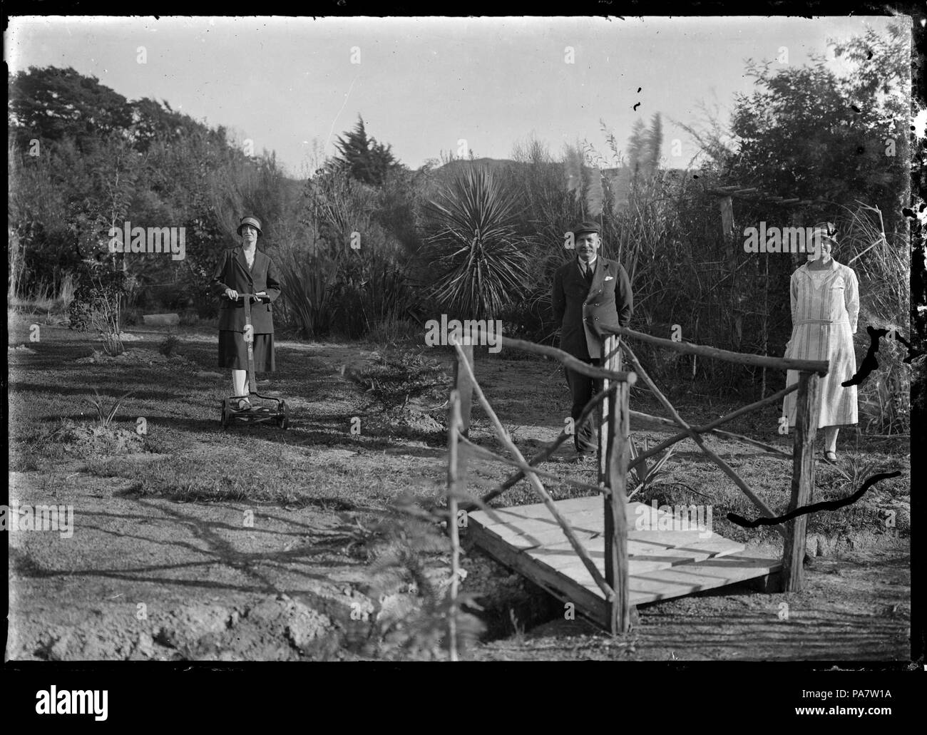 15 Albert Percy Godber standing by a footbridge over a narrow creek ...