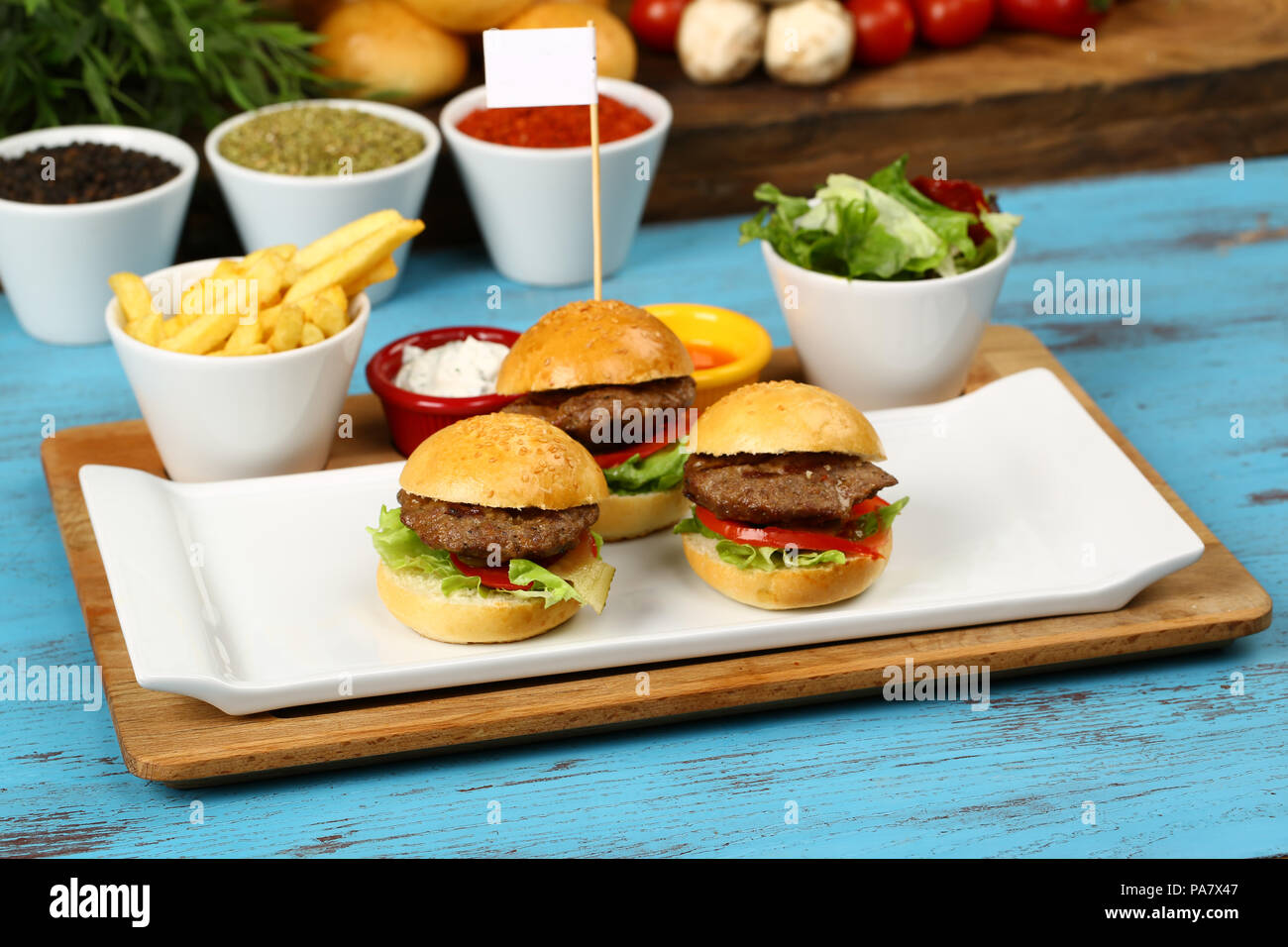 Three mini hamburgers with french fries Stock Photo - Alamy