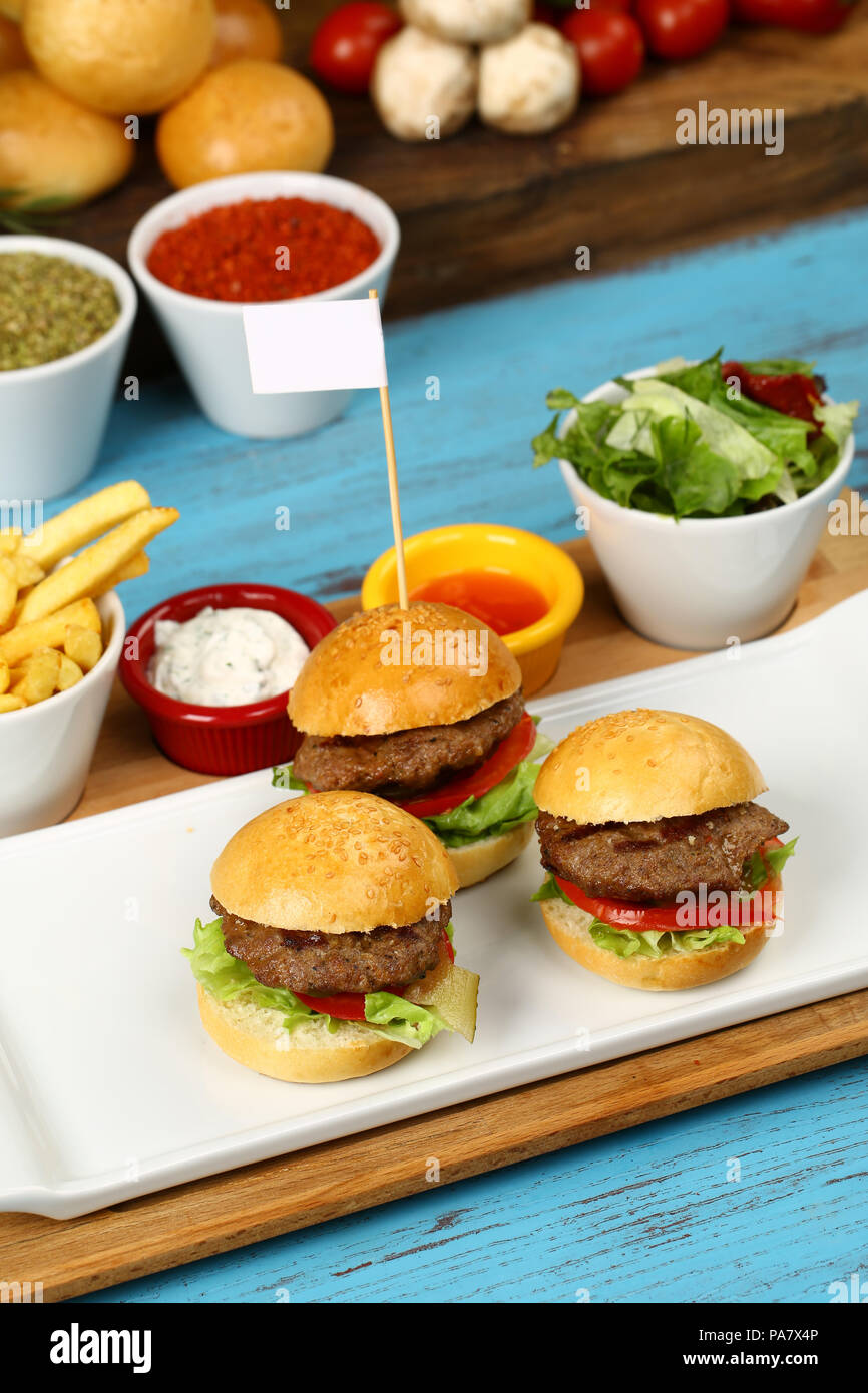Three mini hamburgers with french fries Stock Photo - Alamy