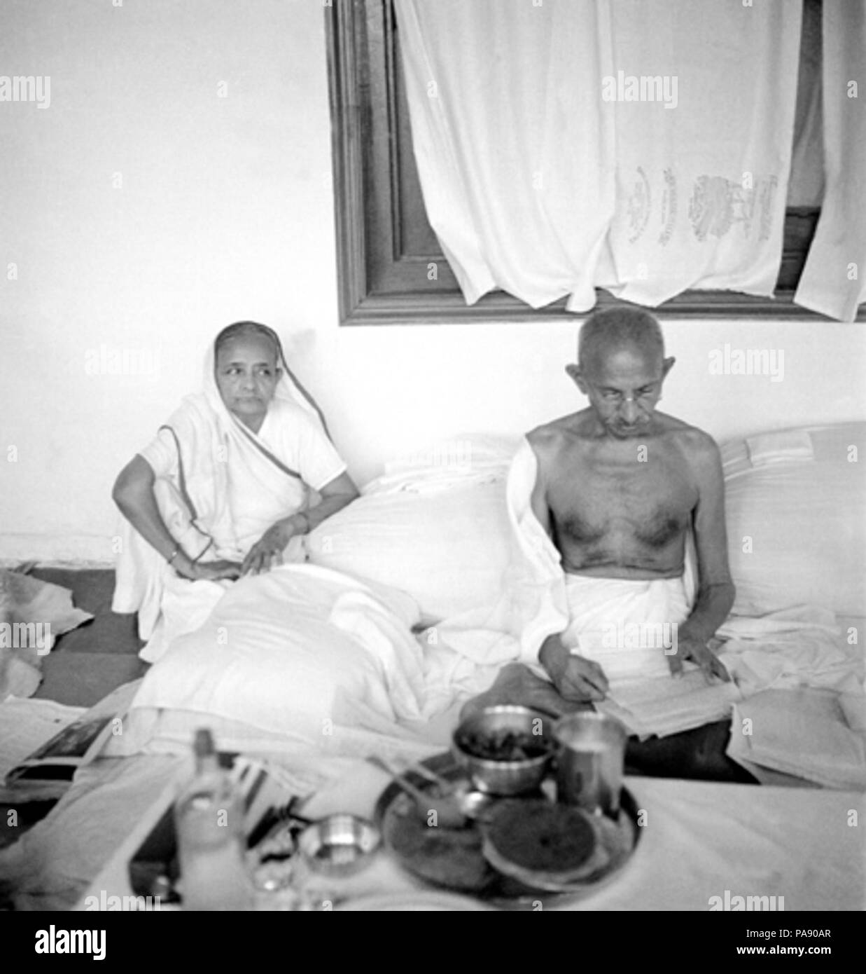 121 Kasturba with Gandhi reading Stock Photo - Alamy