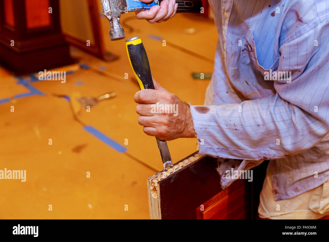 Carpenter makes a hole in new wooden door for the mortise lock with a ...