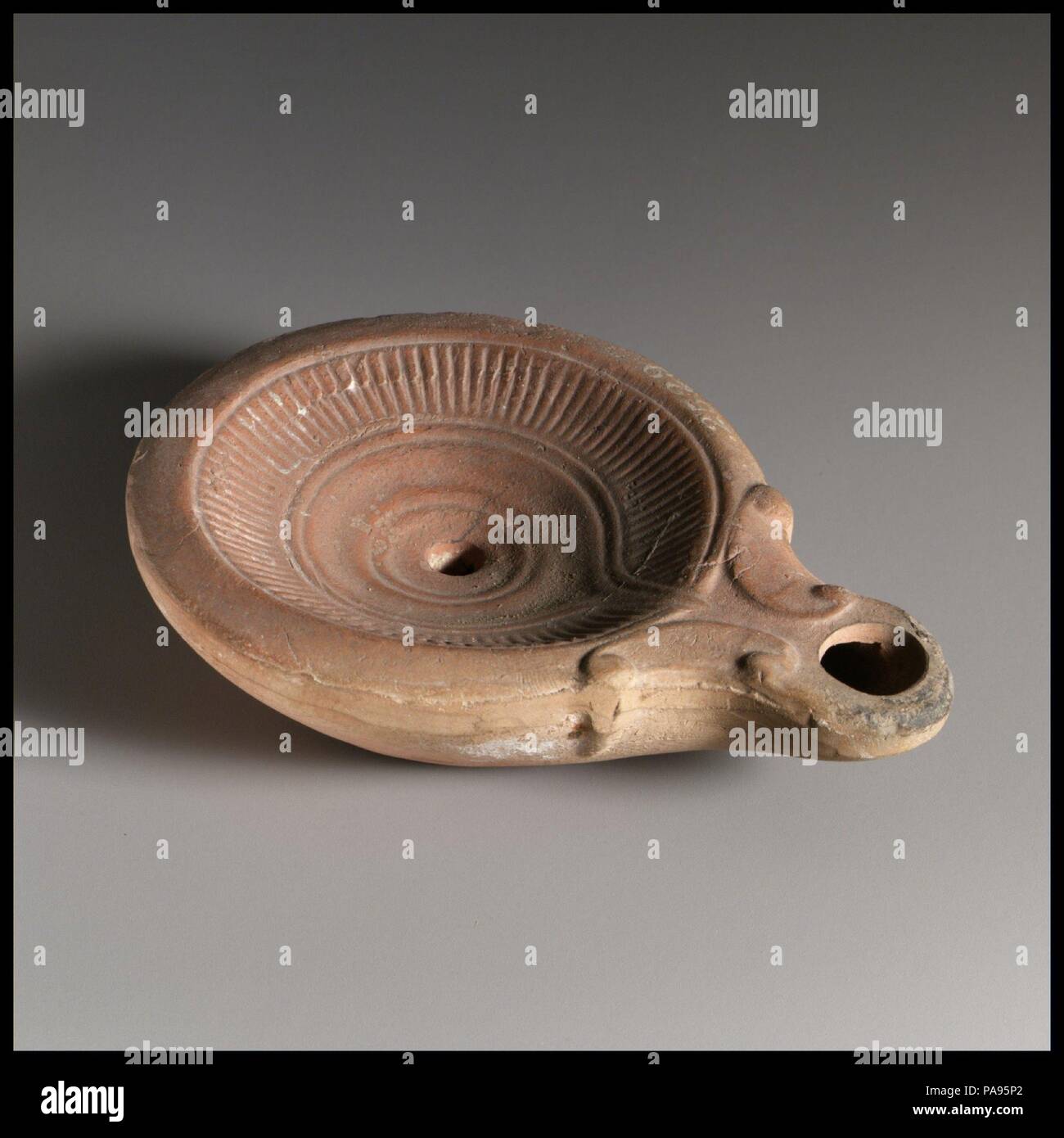 Lamp. Culture: Roman. Dimensions: Overall: 7/8 x 3 1/2 in. (2.2 x 8.9 ...