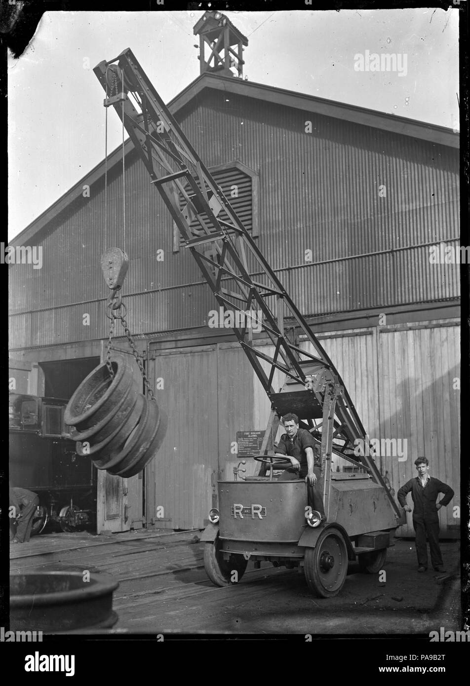 177 Motor driven mobile crane lifting a load of wheel frames at the ...