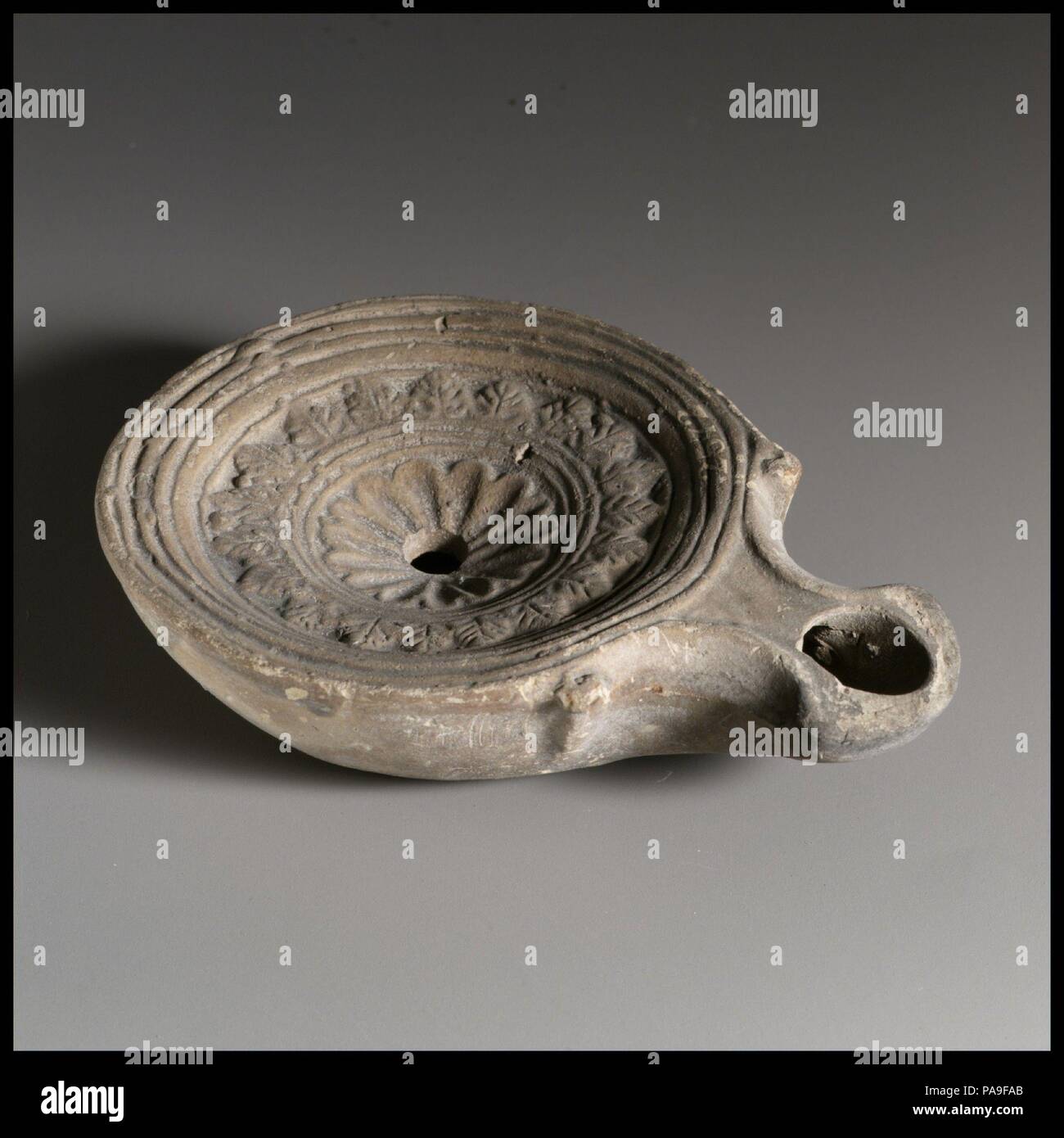 Lamp. Culture: Roman. Dimensions: Overall: 1 x 3 3/4 in. (2.5 x 9.5 cm ...