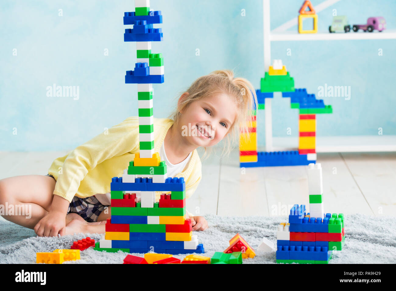 the girl built a tower of cubes. The joy of games Stock Photo - Alamy