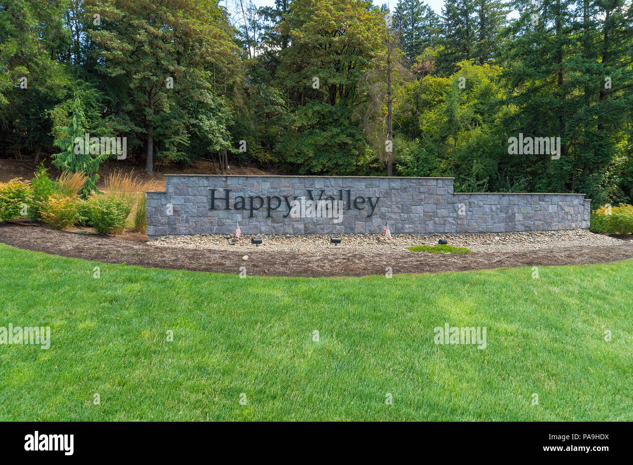 City of Happy Valley Oregon stone wall sign in the park with green ...