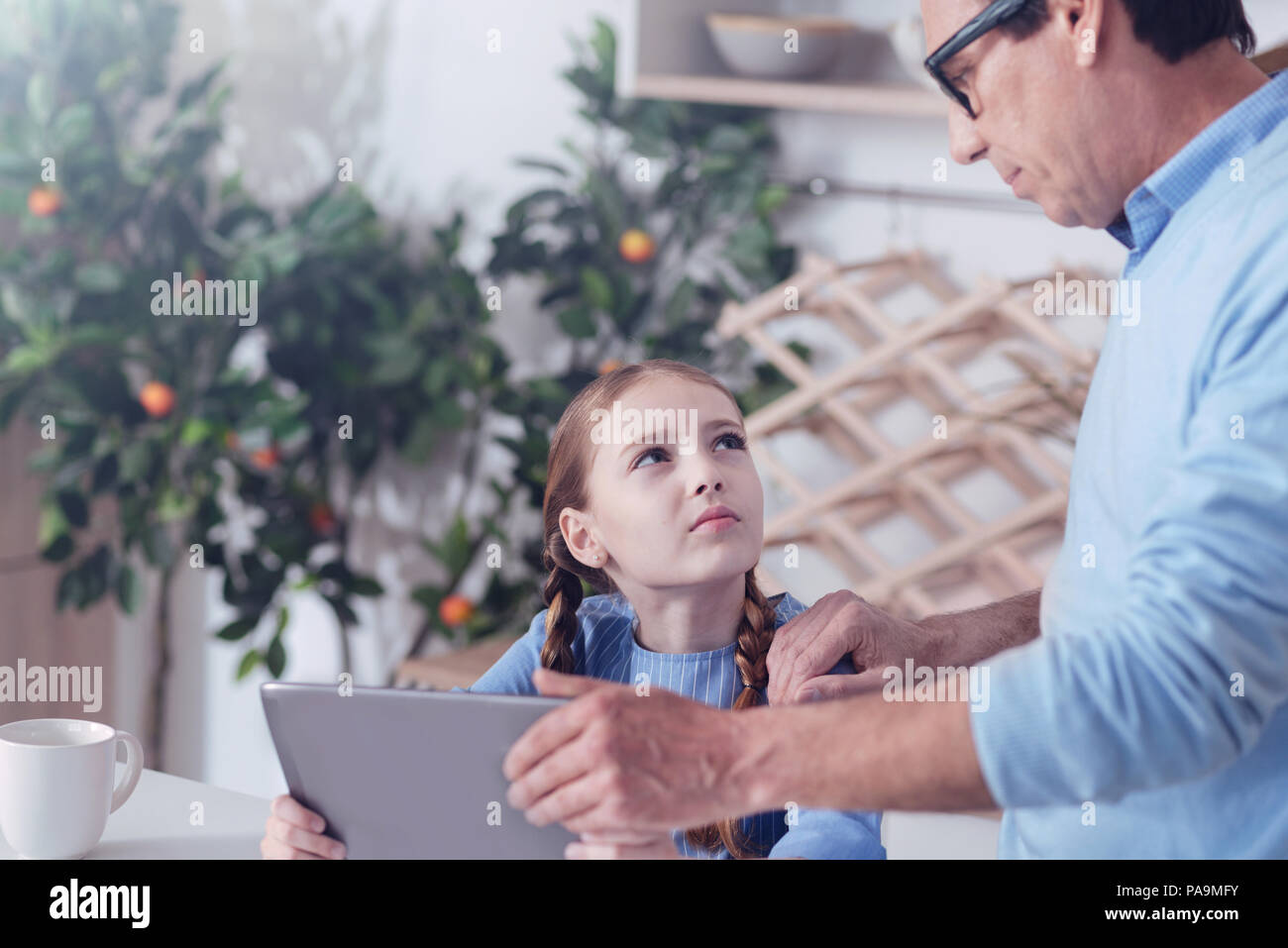 Nice smart girl looking at her father Stock Photo - Alamy
