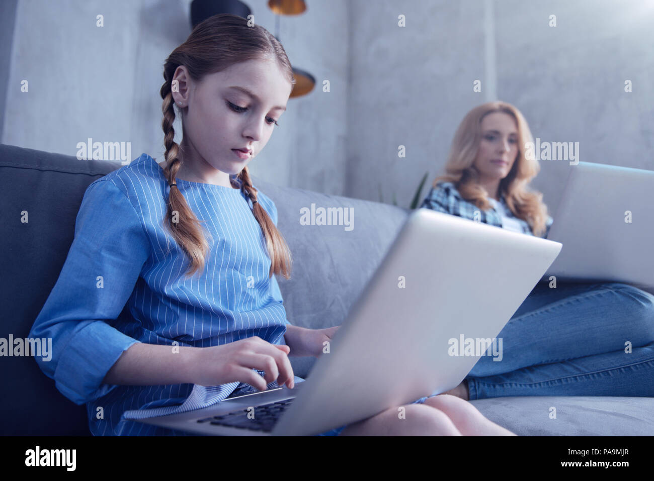 Serious cute girl pressing a button Stock Photo - Alamy