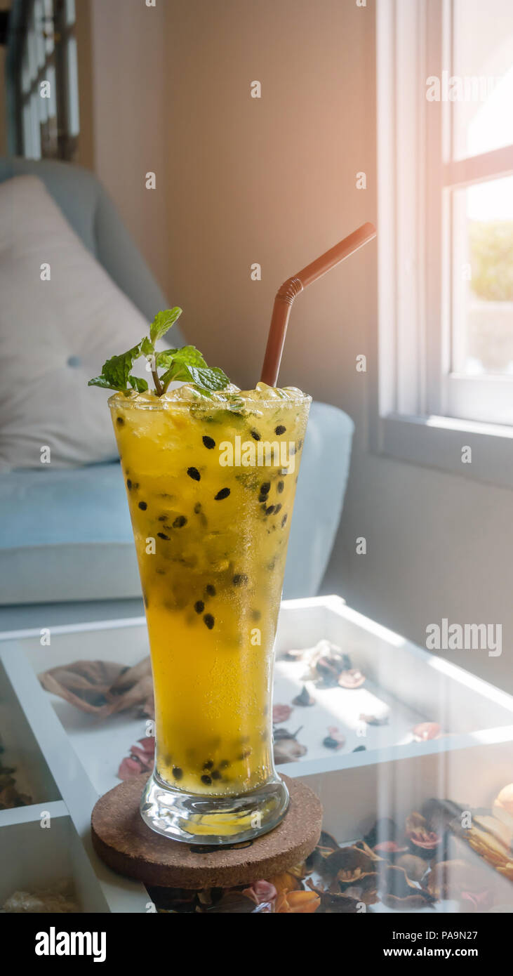 Passion fruit juice with ice cubes and drinking straws Stock Photo - Alamy