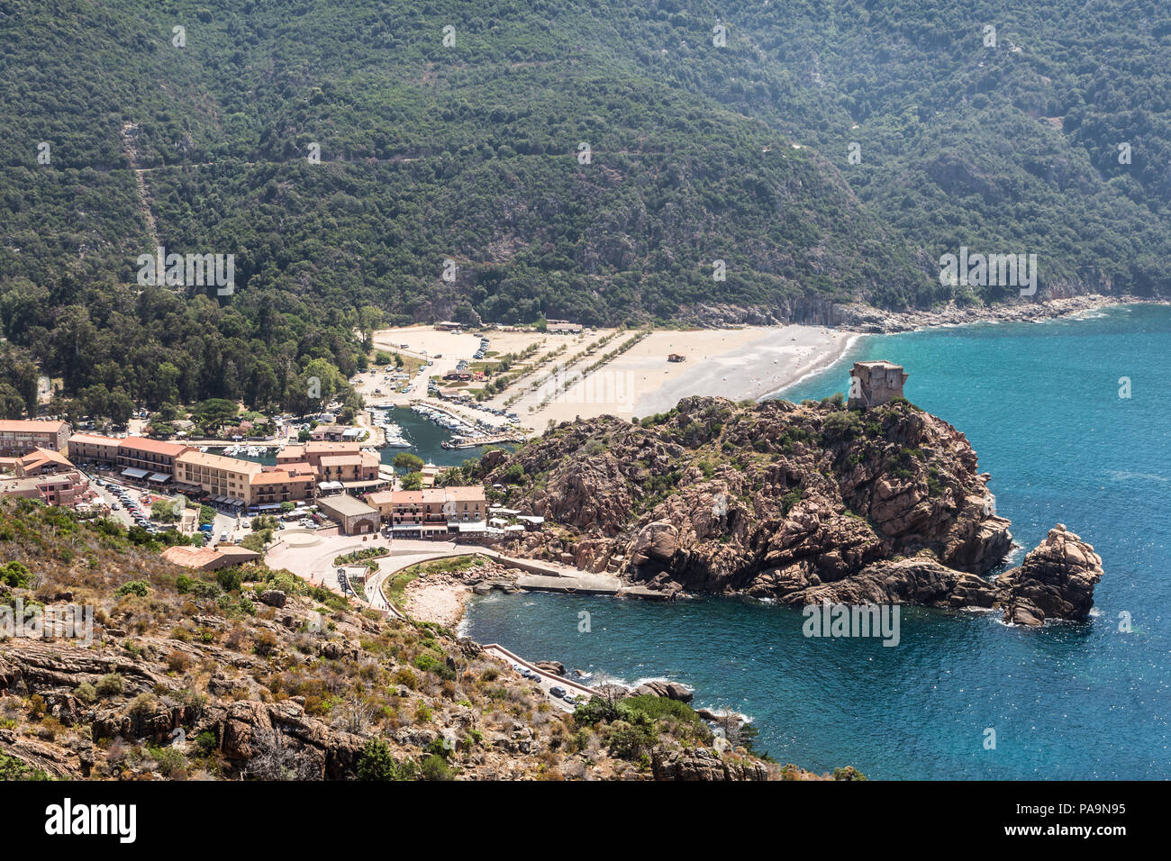 The resort town of Porto with its medieval fortification tower on a ...