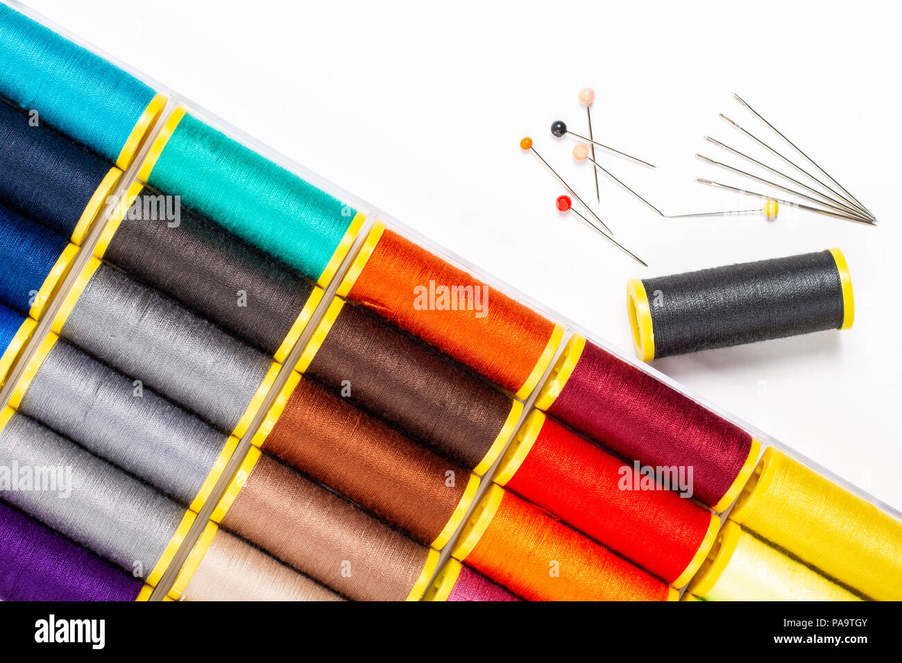 DIY concept multicolor Sewing thread and needle on white back ground ...