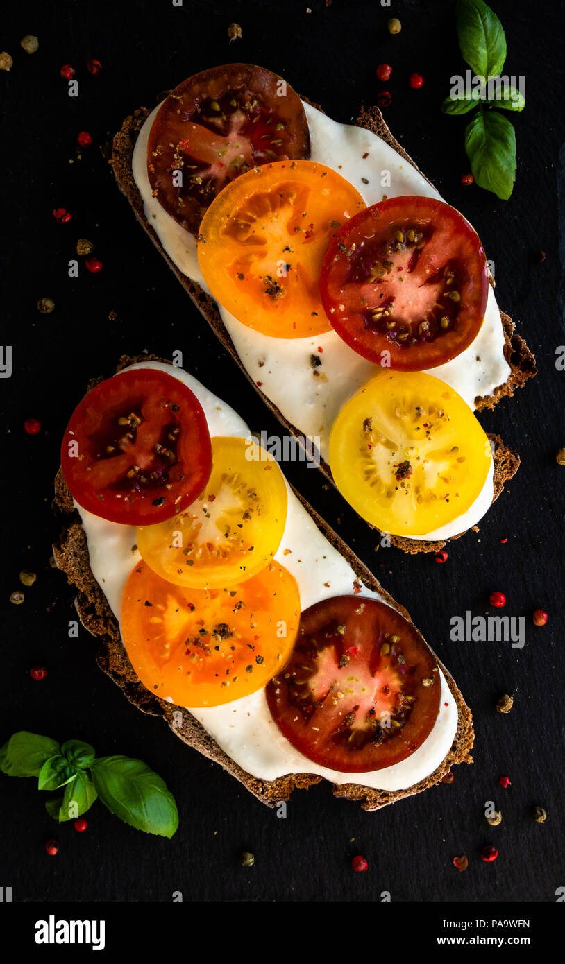 rye bread with cream cheese and color tomatoes Stock Photo - Alamy