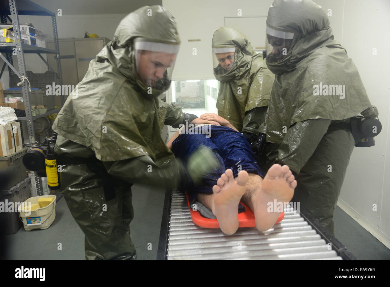 A patient decontamination team uses mock M-9 tape to determine if a ...