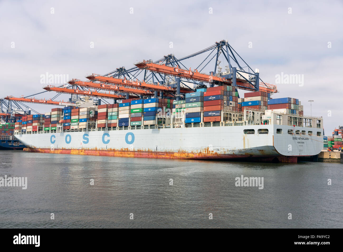 Container terminal in Dutch harbor Rotterdam with cargo ships moored ...