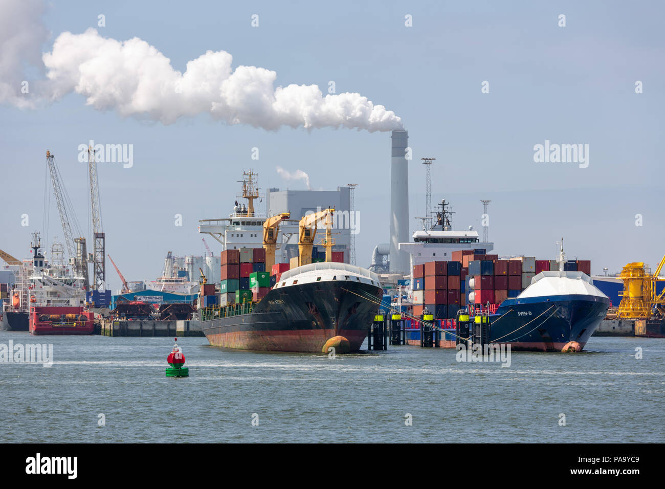 Container terminal in Dutch harbor Rotterdam with cargo ships moored ...