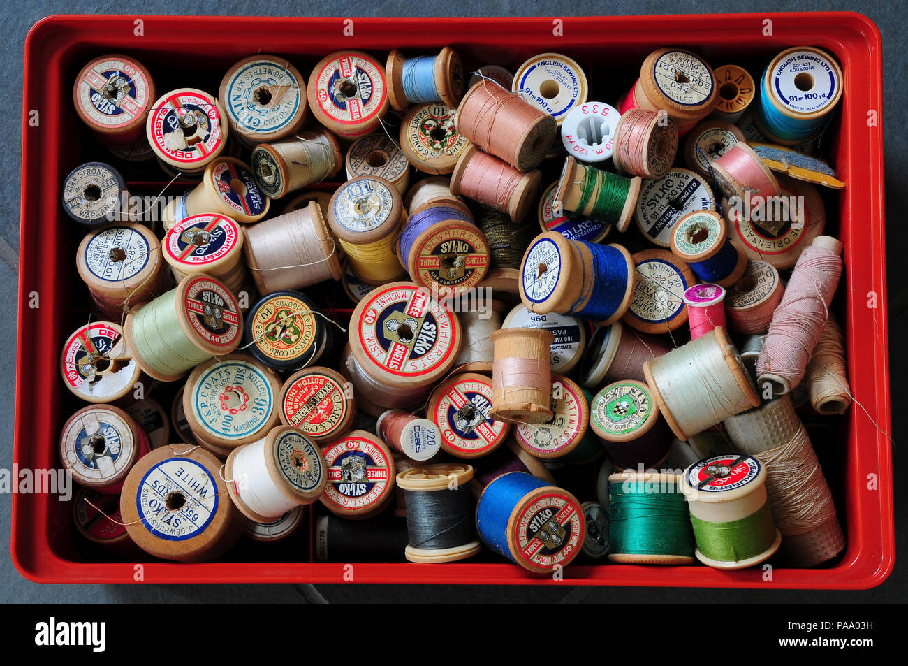 Cotton reels in plastic storage box Stock Photo - Alamy