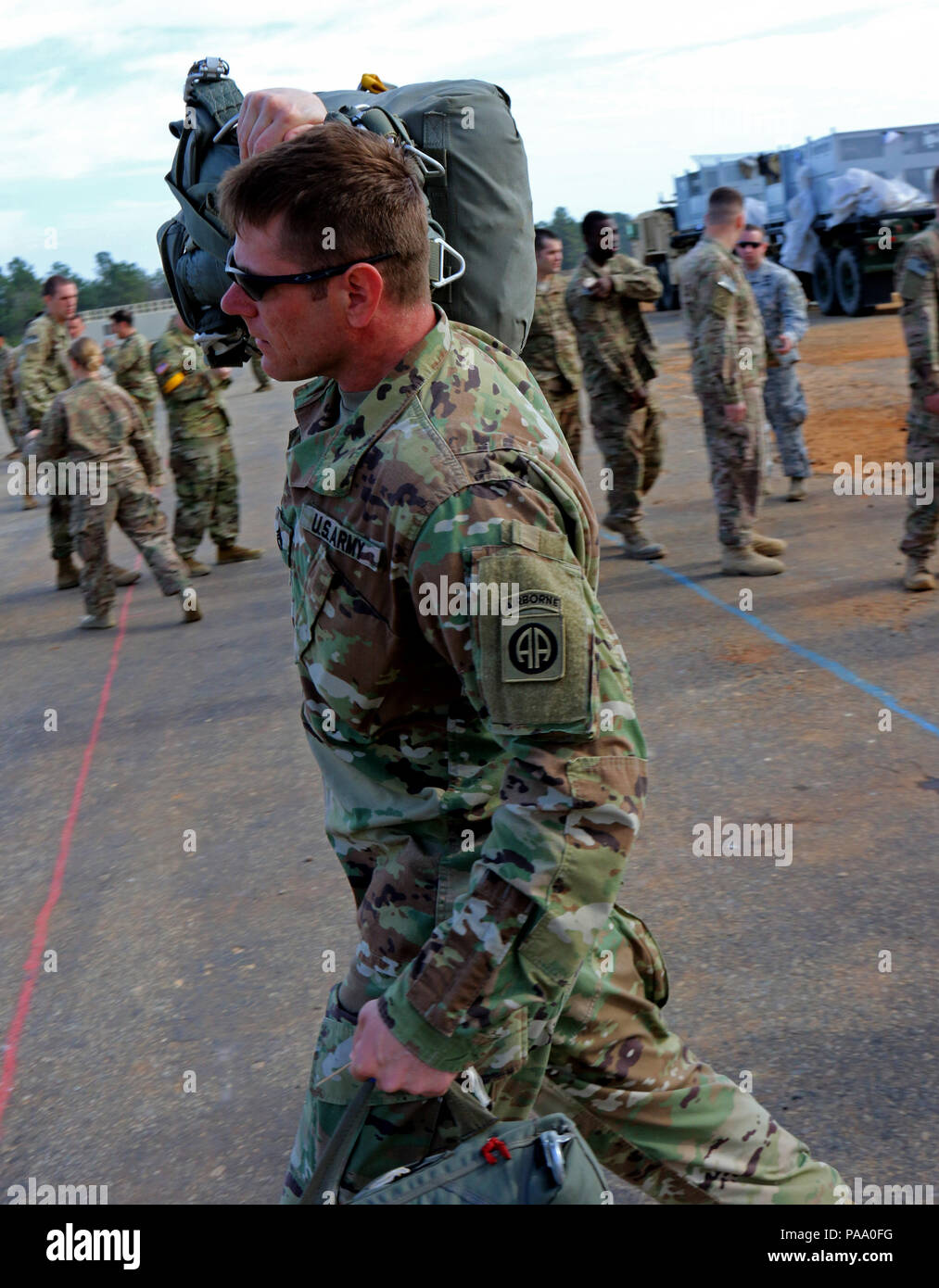 Staff Sgt. Jason Hull picks up his T-11 Parachute during a reenlistment ...