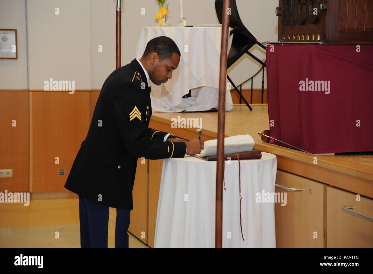 An inductee signs his noncommissioned officer charge orders during the ...