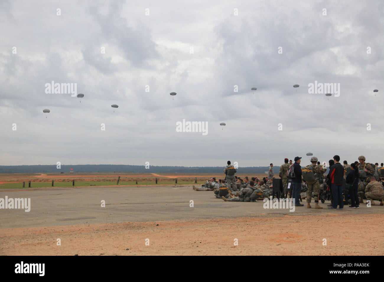 U.S. Army paratroopers and their families watch as other paratroopers ...