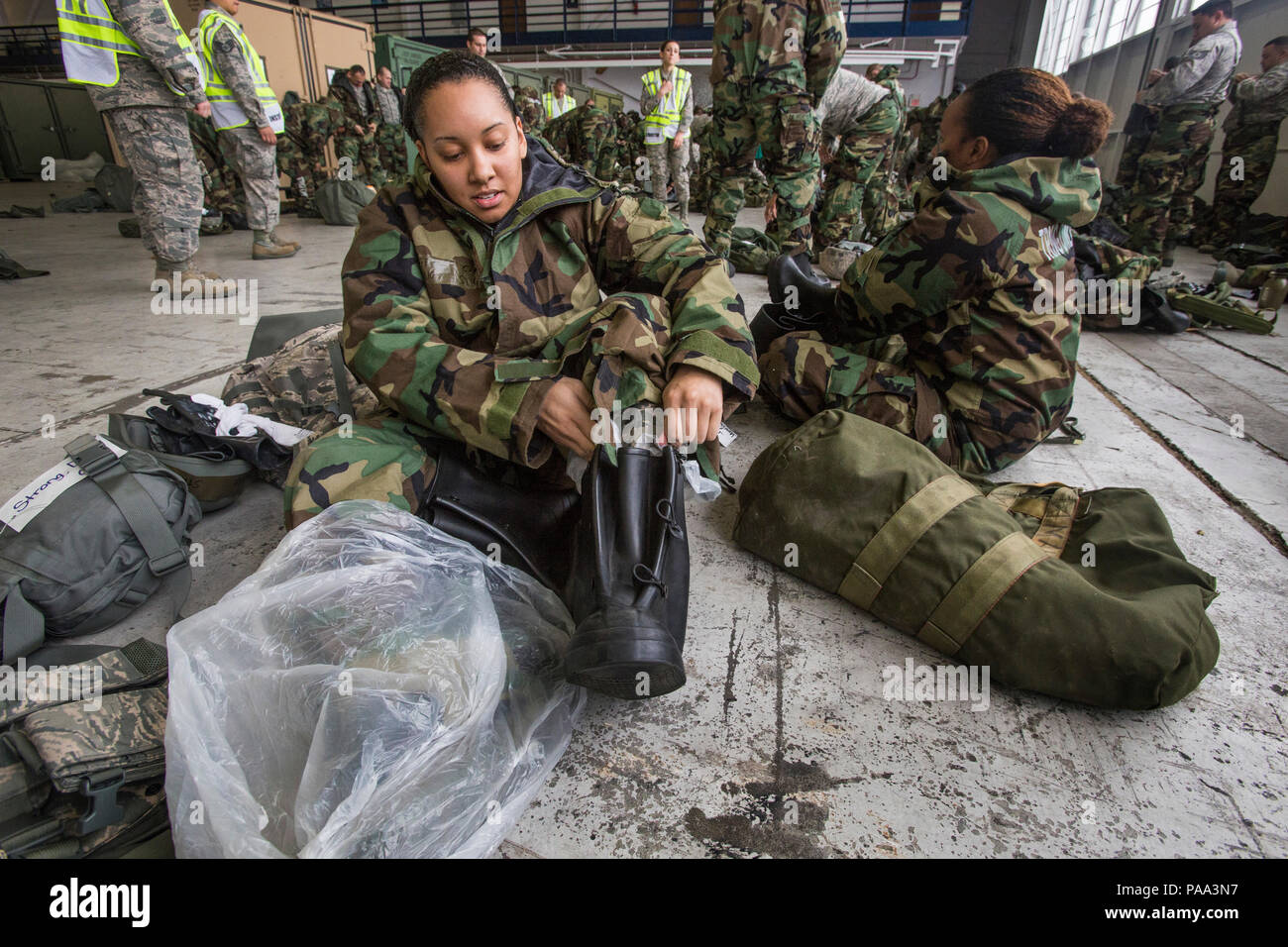 An Airman with the 108th Wing, New Jersey Air National Guard, dons her ...